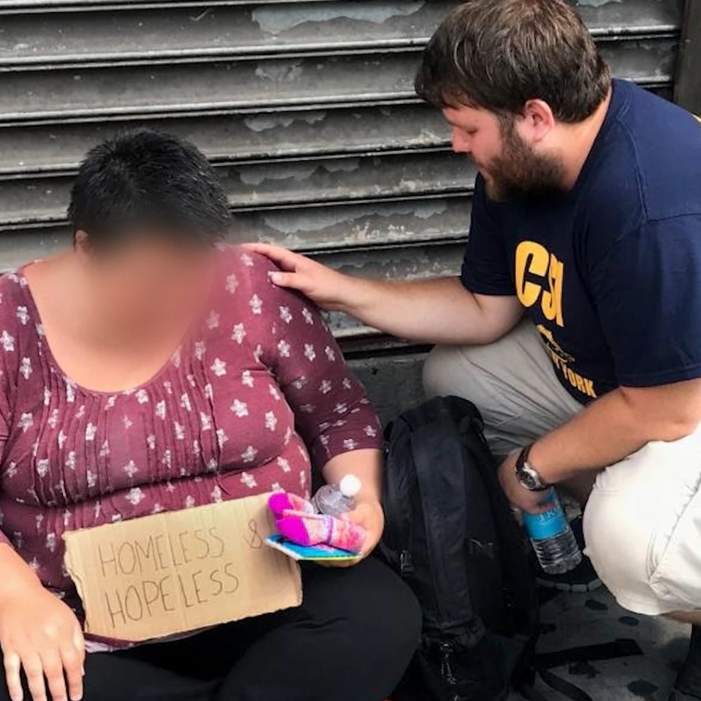 Praying with a homeless woman | Riverside Baptist Church